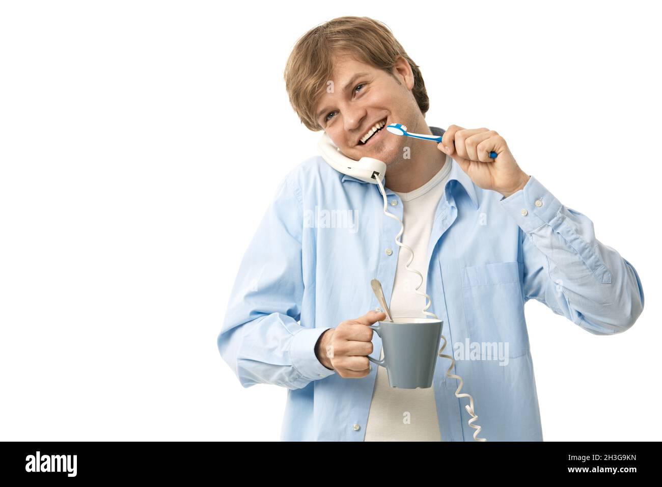 Young man talking on phone while brushing teeth Stock Photo - Alamy