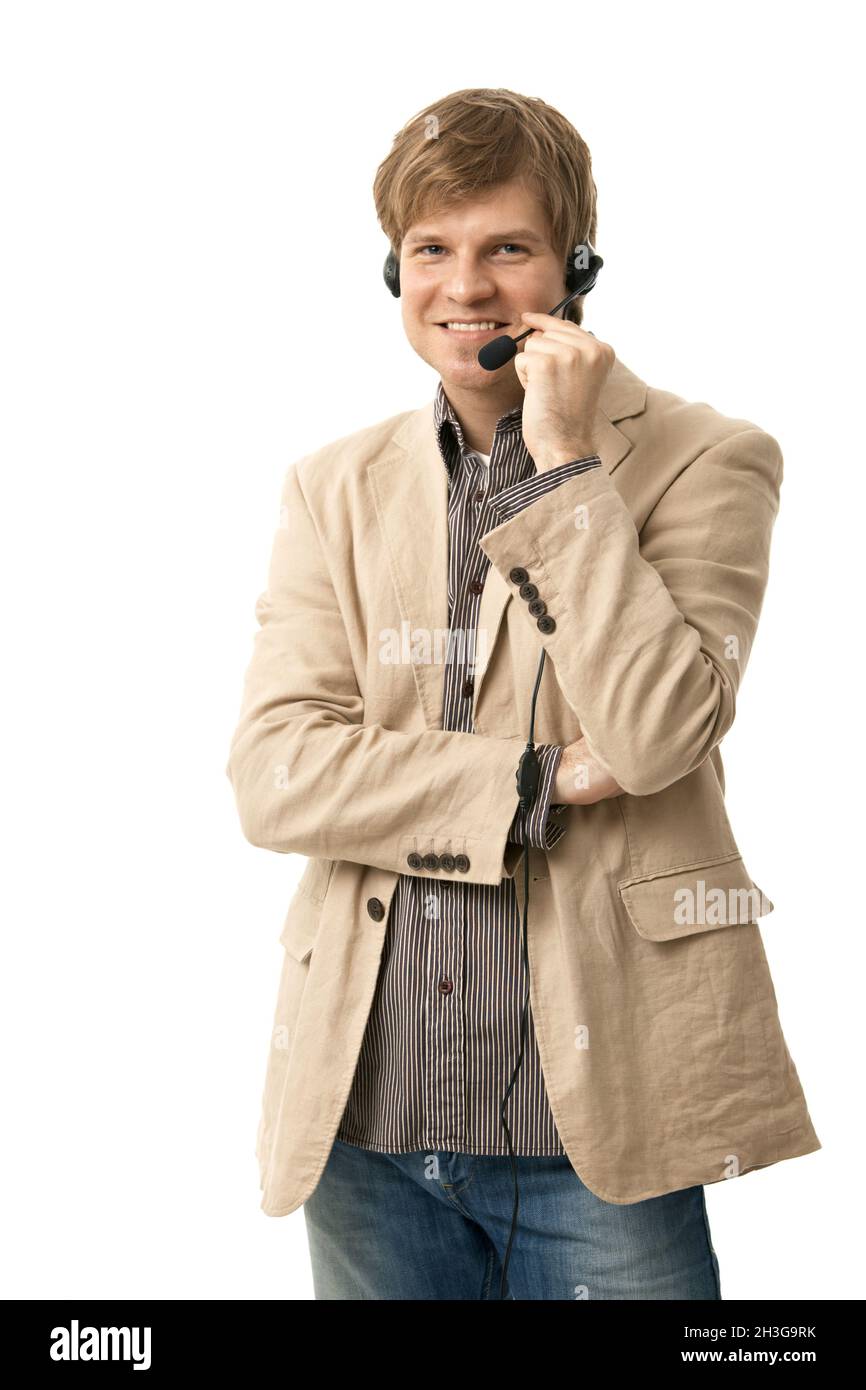 Casual man standing talking on headset Stock Photo - Alamy