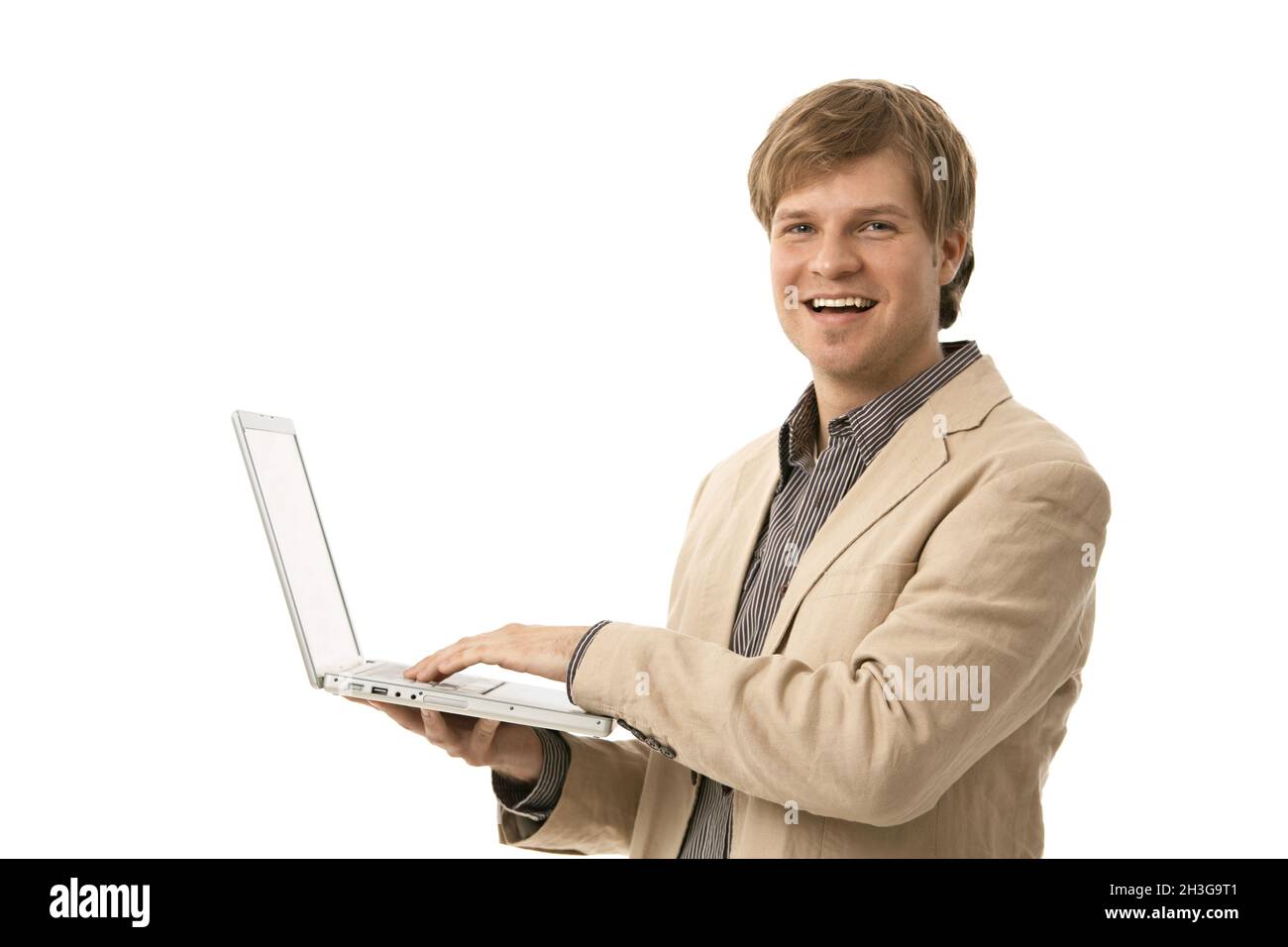 Young man holding computer Stock Photo - Alamy