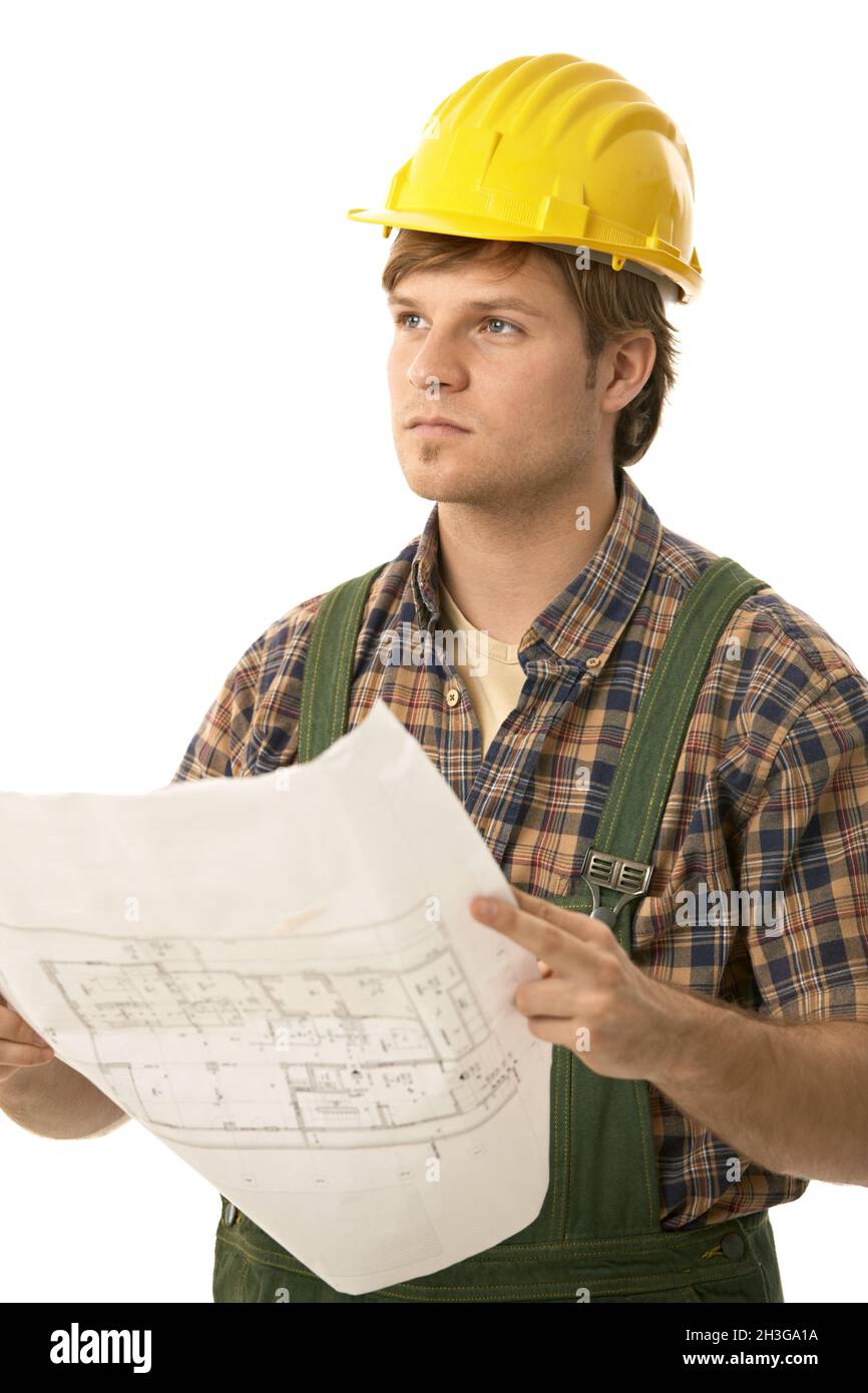 Young builder holding floor plan Stock Photo - Alamy