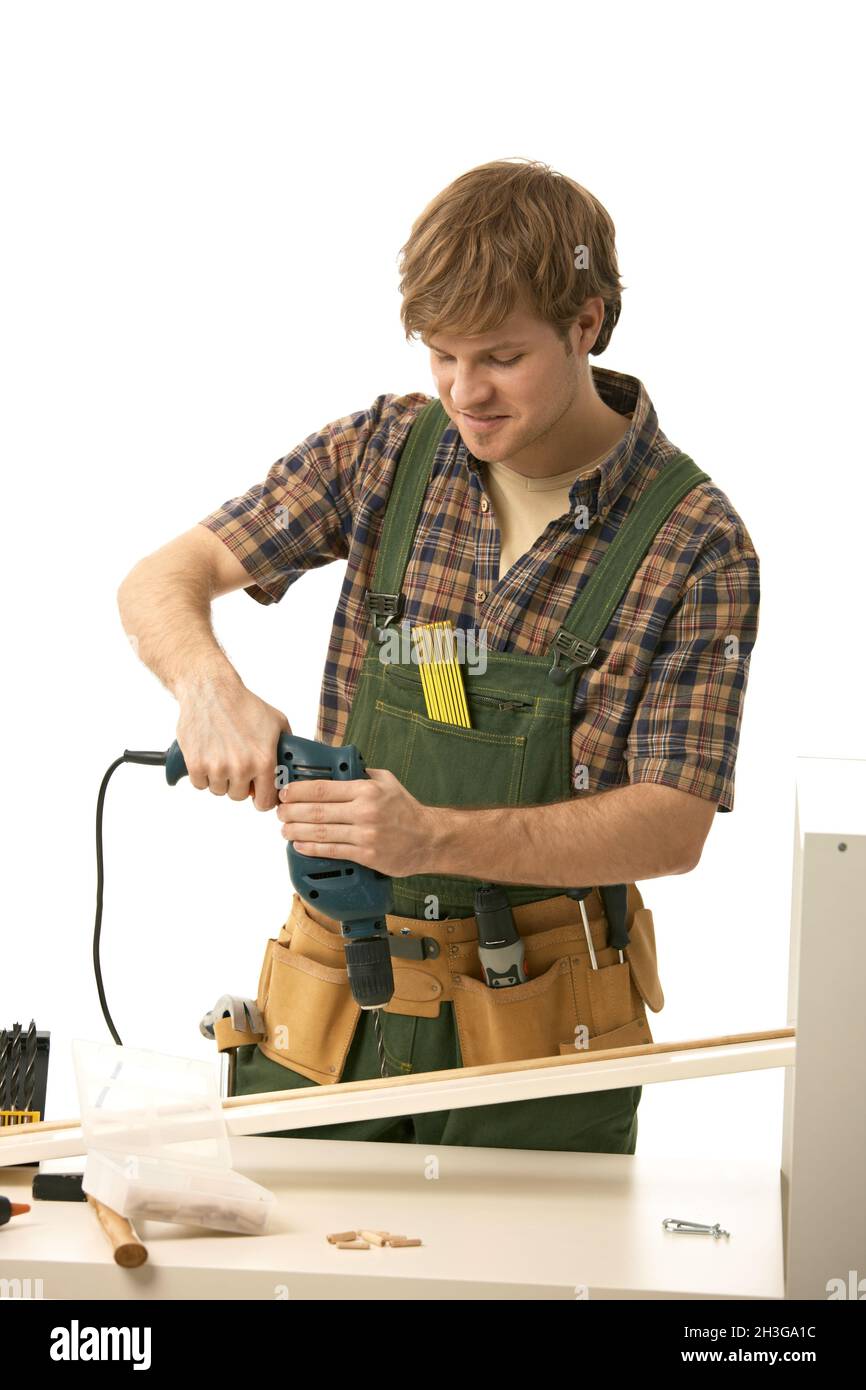 Happy young man tinkering Stock Photo - Alamy