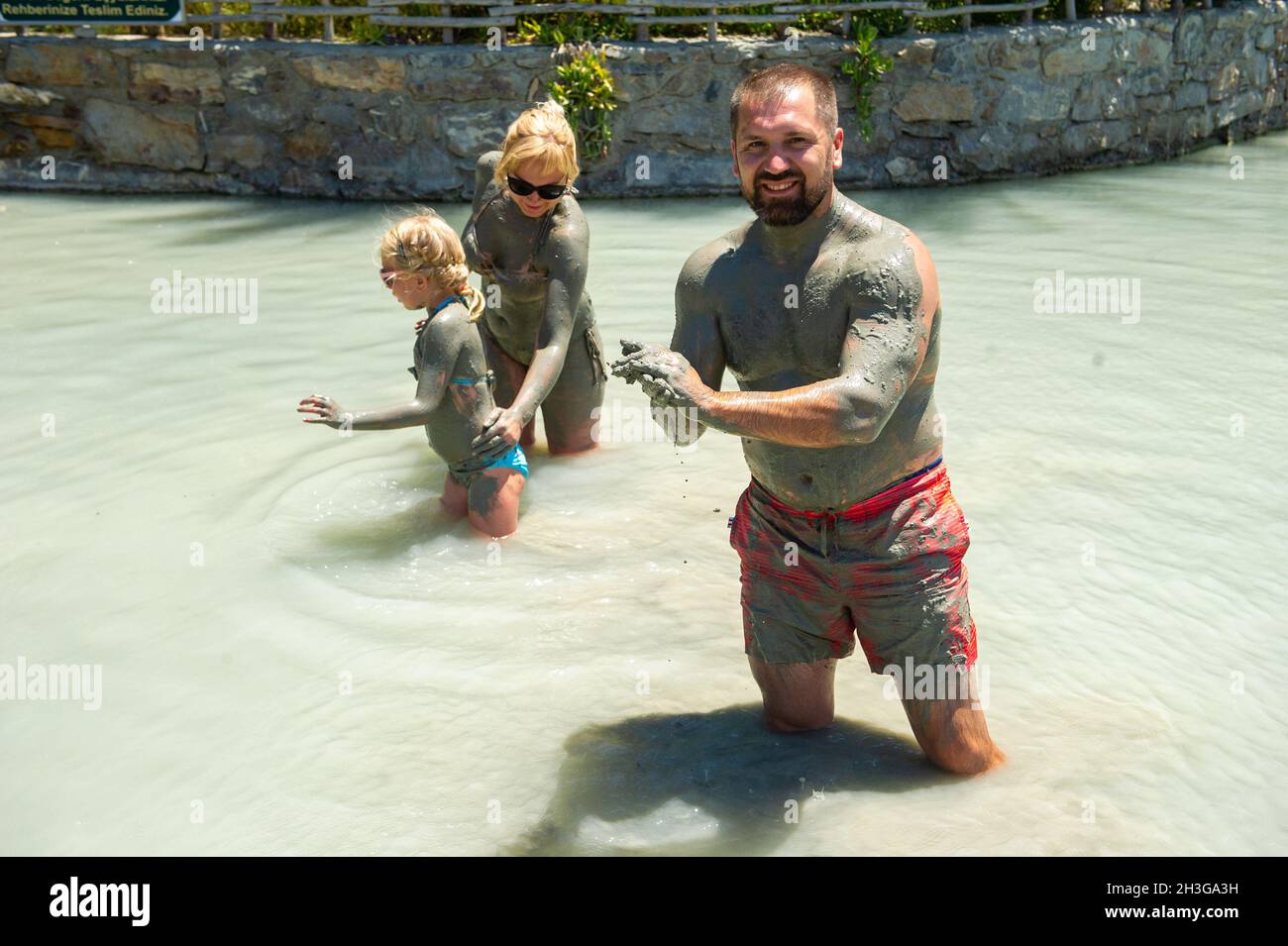 A happy family takes a mud bath at a resort in Turkey.Family wellness ...