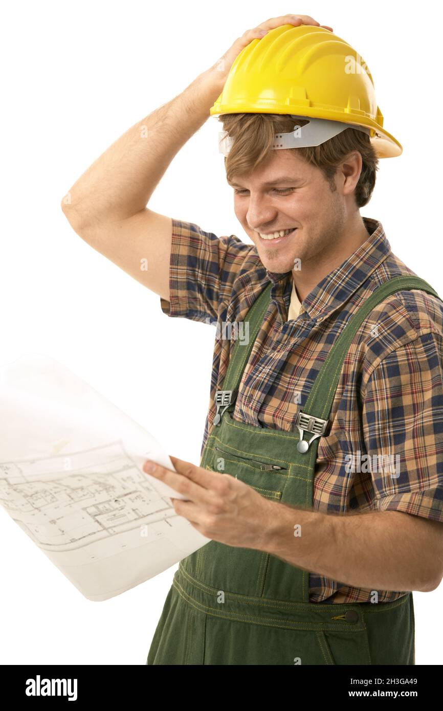 Confident handyman looking at floor plan Stock Photo - Alamy