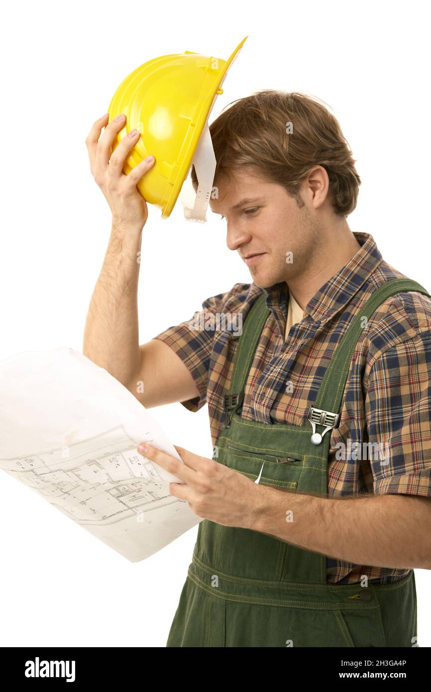 Young builder looking at floor plan Stock Photo - Alamy