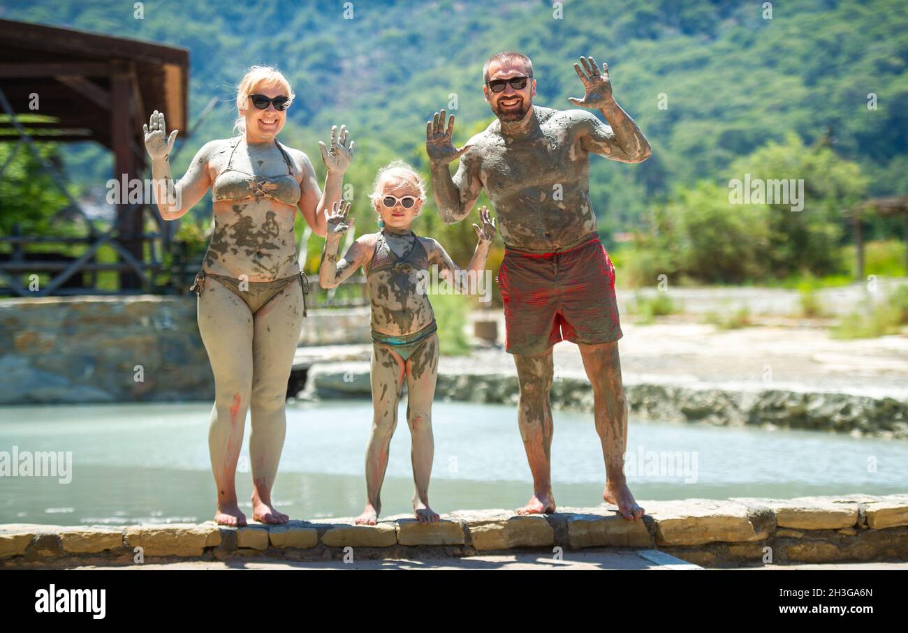 A happy family takes a mud bath at a resort in Turkey.Family wellness ...