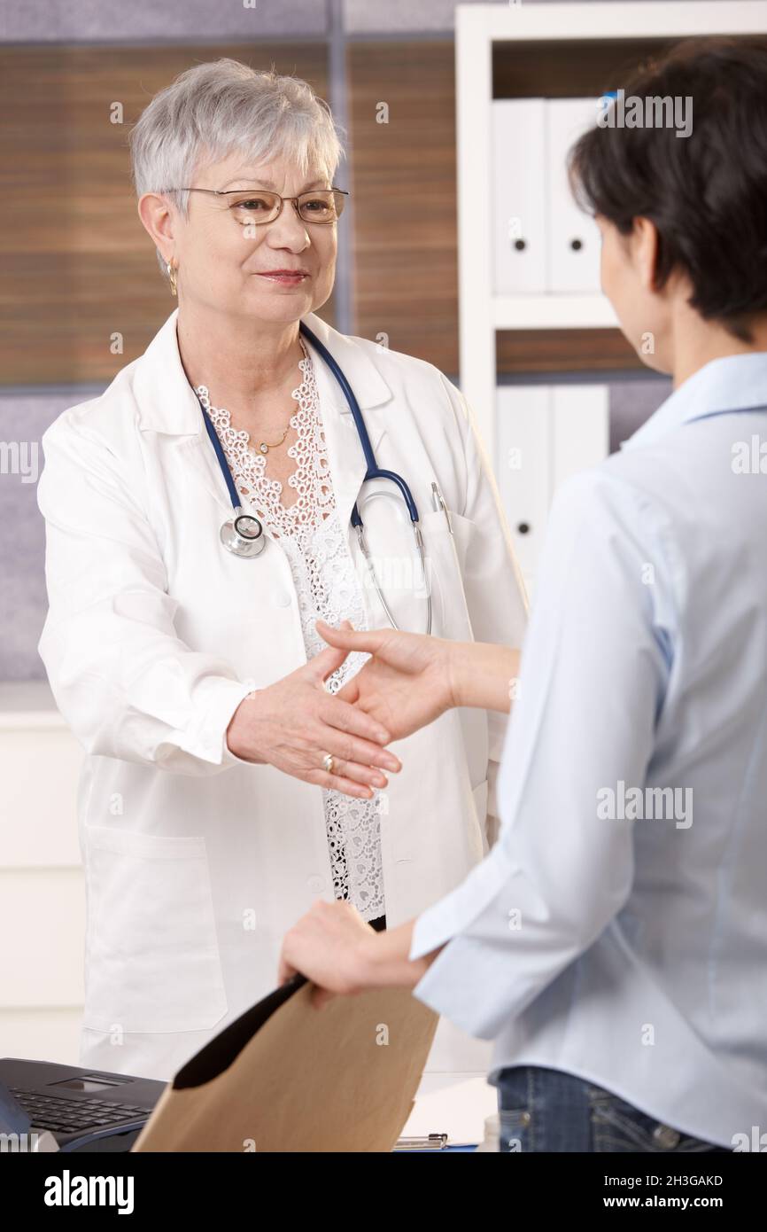 Doctor greeting patient Stock Photo - Alamy