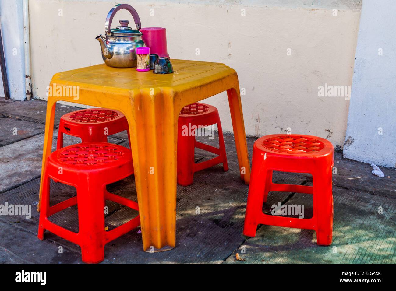 Table and chairs belonging to a street food stall in Yangon, Myanamar ...