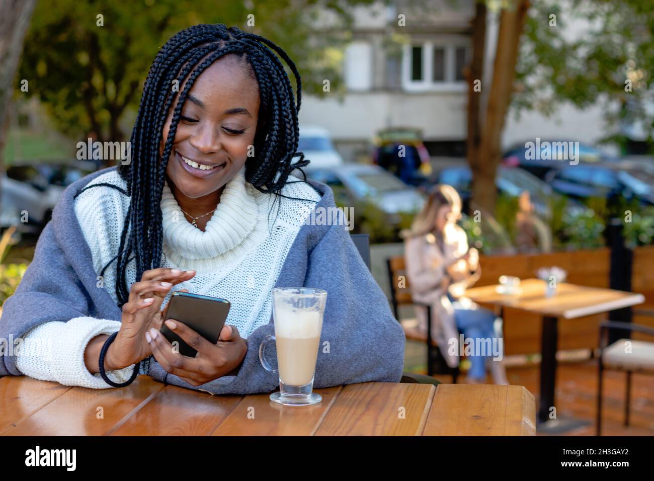 Black girl texting sitting table hi-res stock photography and images ...