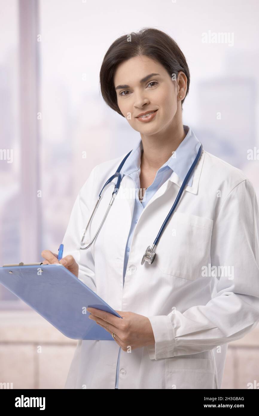 Female doctor doing paperwork in hospital Stock Photo - Alamy