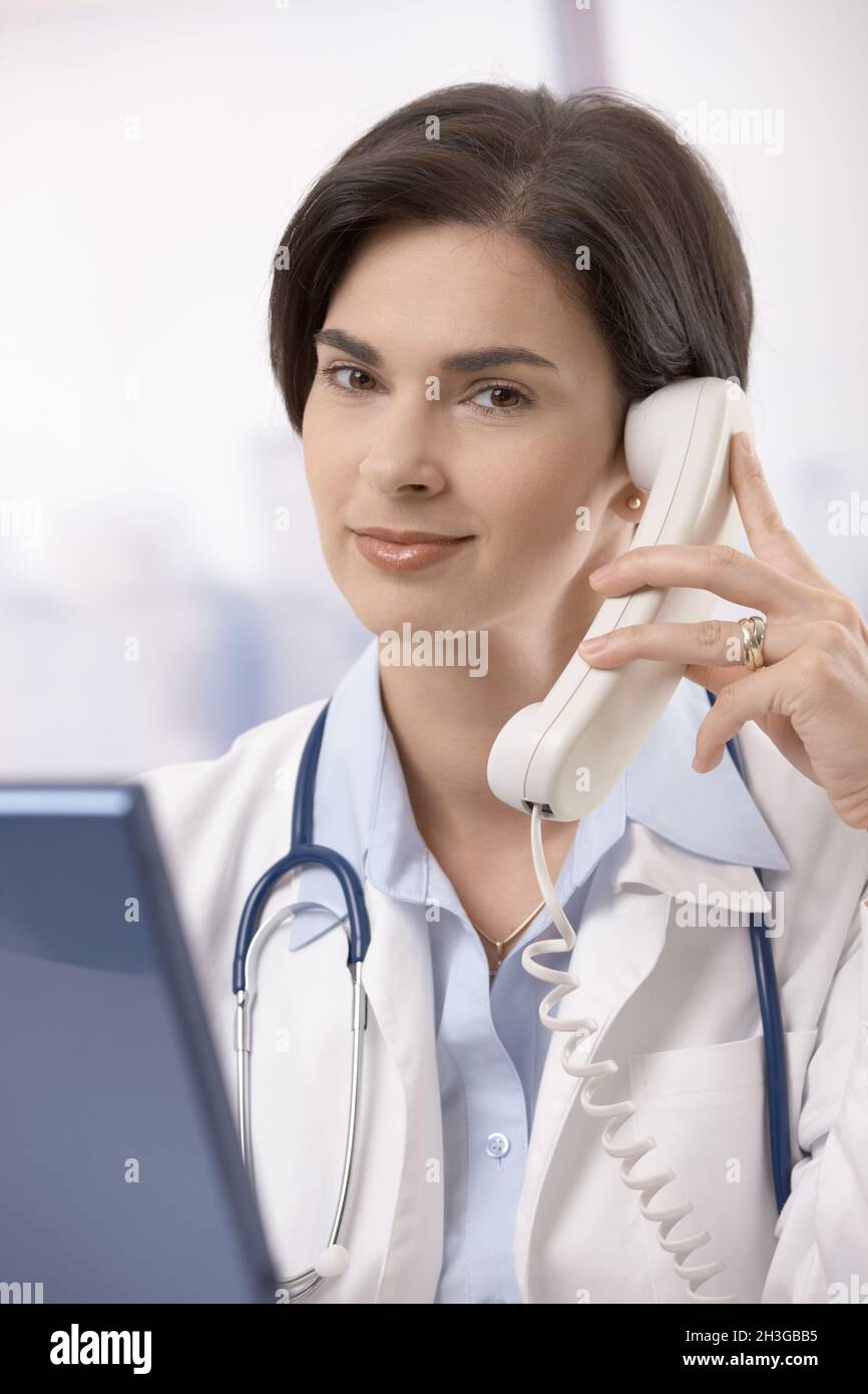Female doctor calling Stock Photo - Alamy