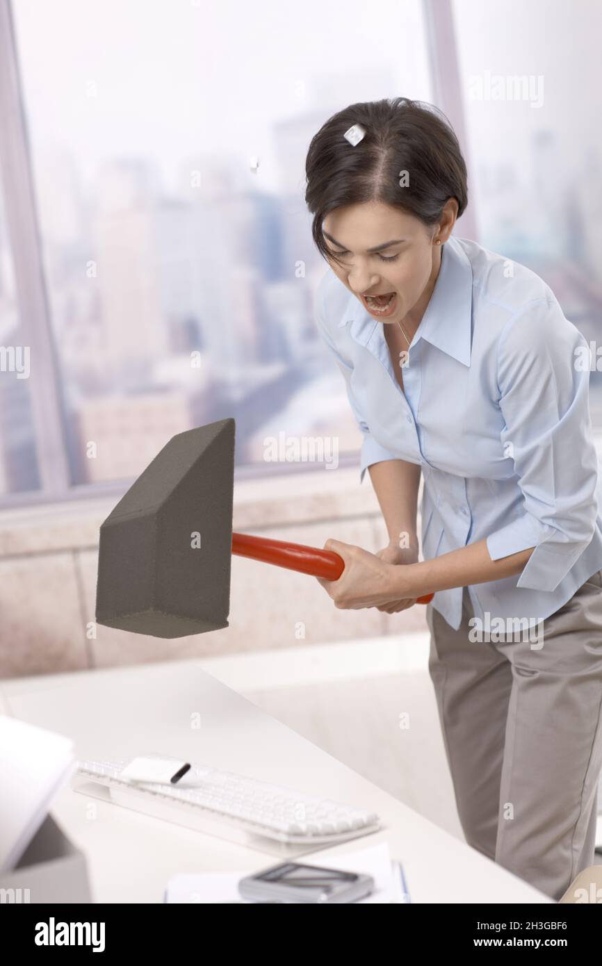 Frustrated office worker smashing keyboard Stock Photo - Alamy