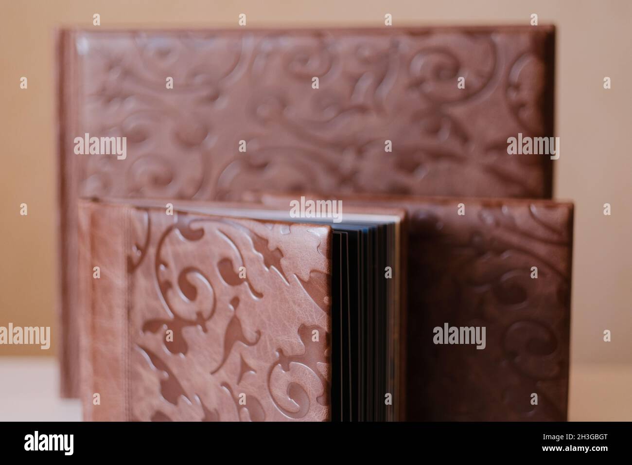 Composition of photo books in natural brown leather of different sizes ...