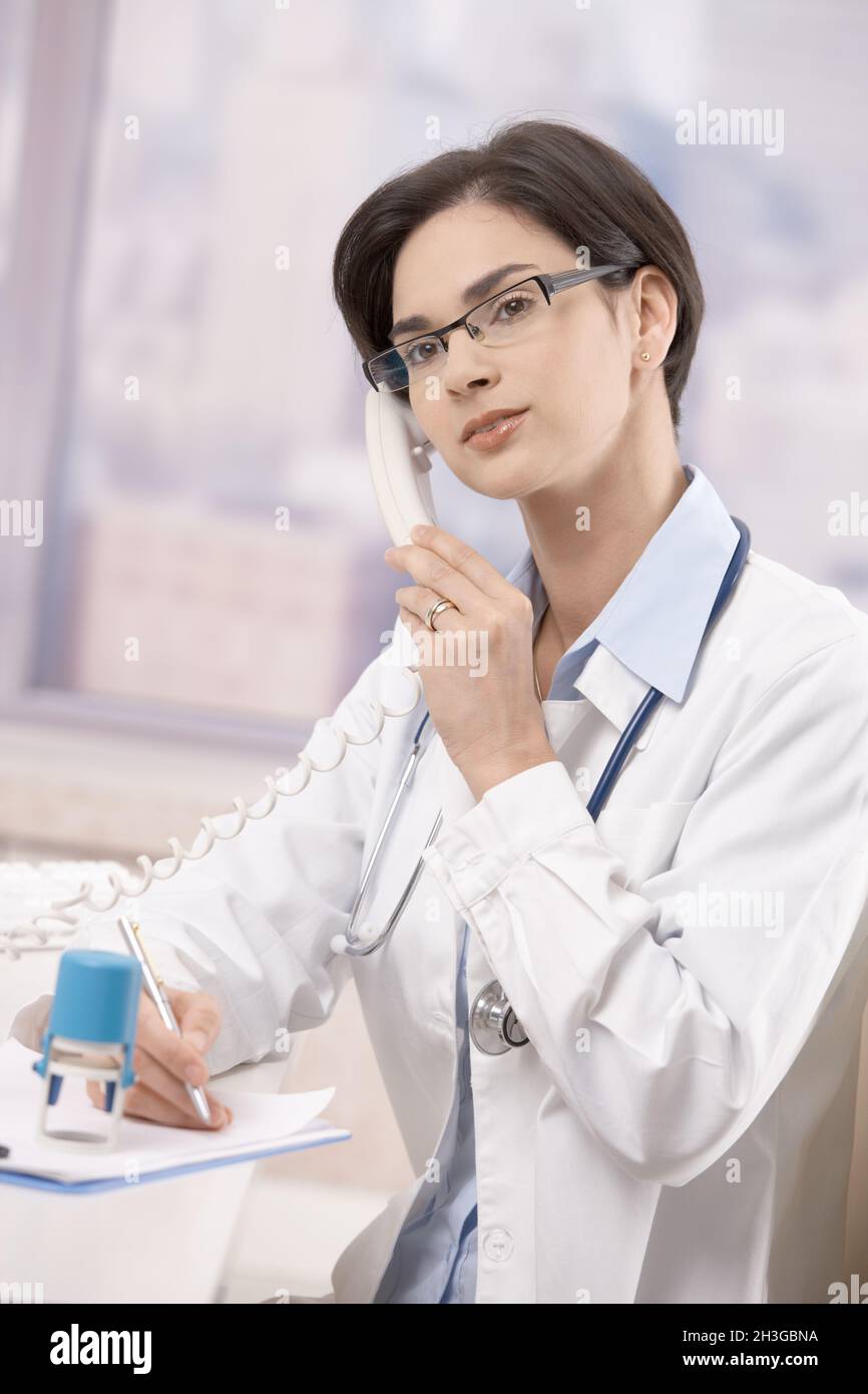 Clinician on phone hi-res stock photography and images - Alamy