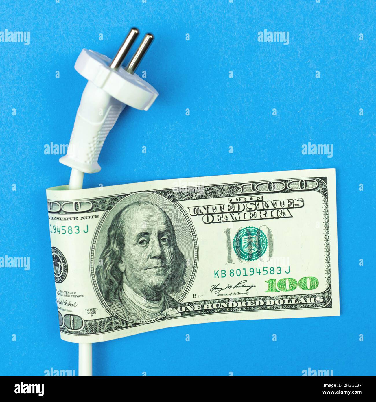 Electricity costs. Electrical power cable and money, dollar bills ...