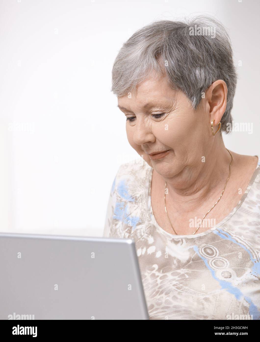 Vertical screen female using laptop hi-res stock photography and images ...