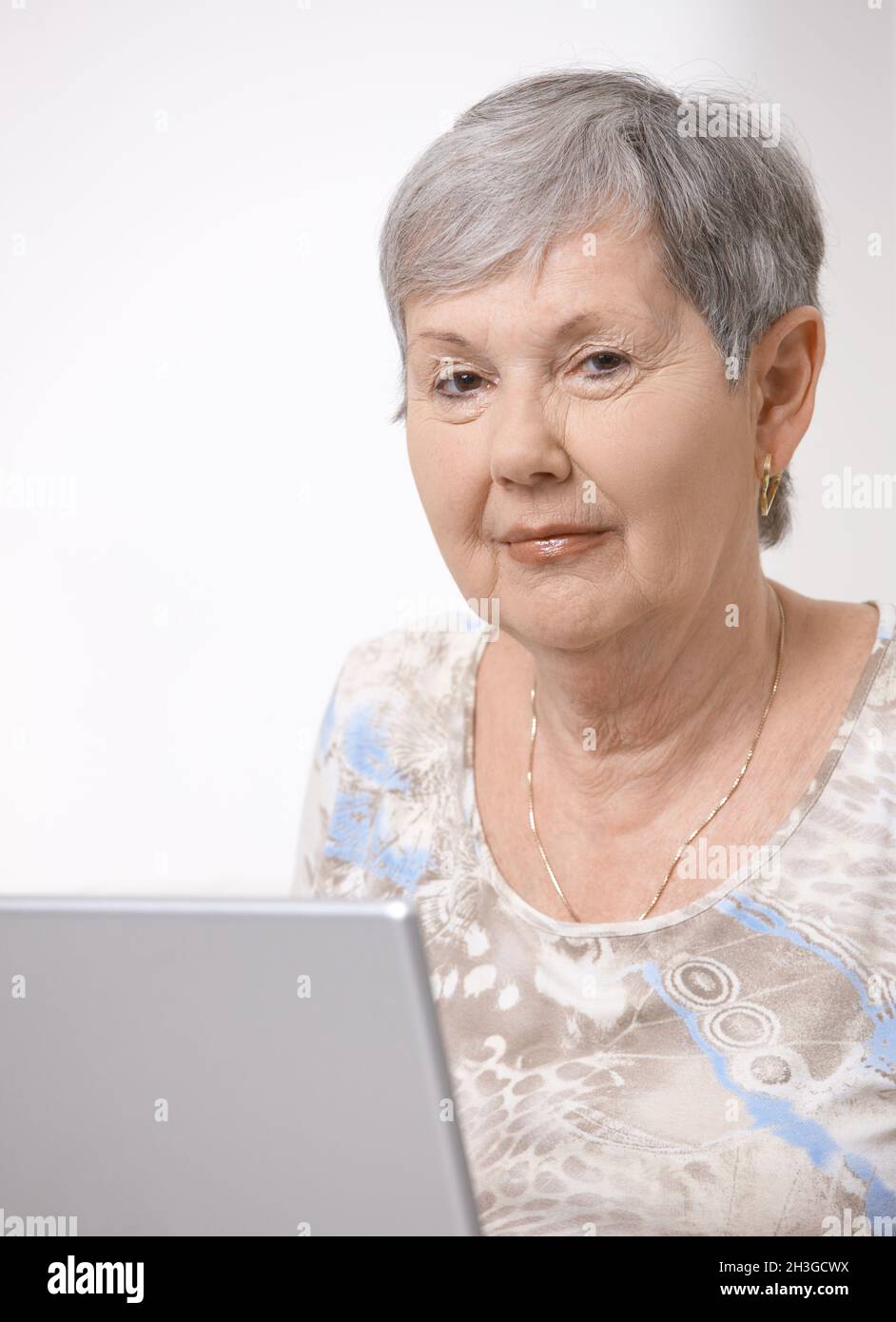 Senior woman using laptop computer Stock Photo - Alamy