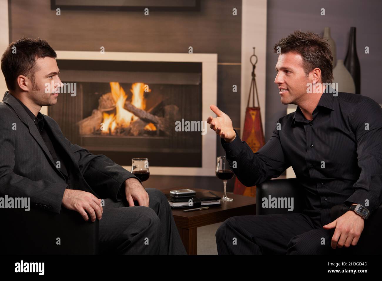 Businessmen talking in club Stock Photo - Alamy