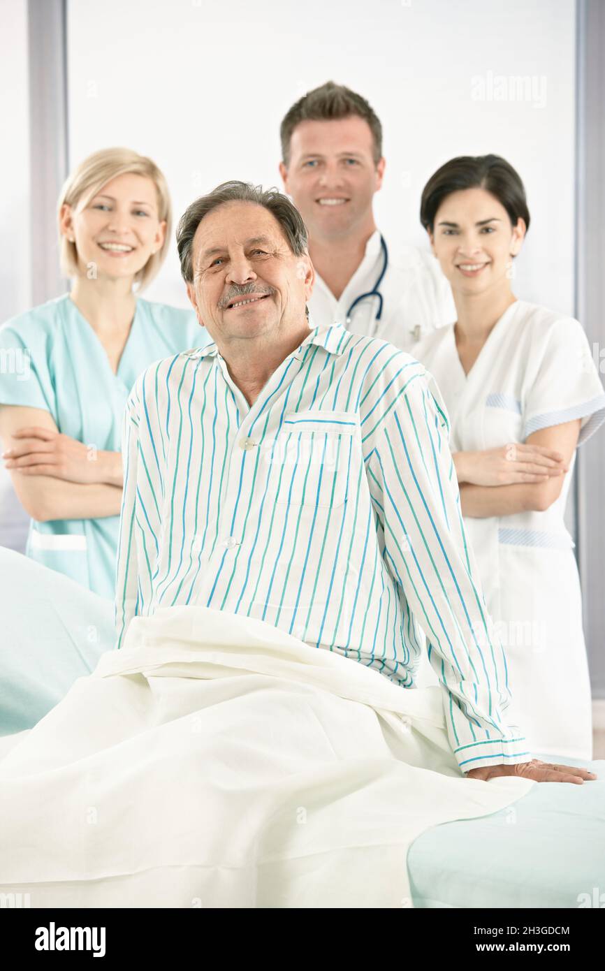 Smiling medical team with patient Stock Photo - Alamy