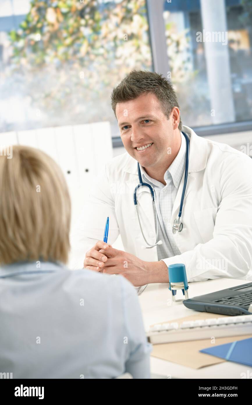 Doctor consulting patient Stock Photo - Alamy
