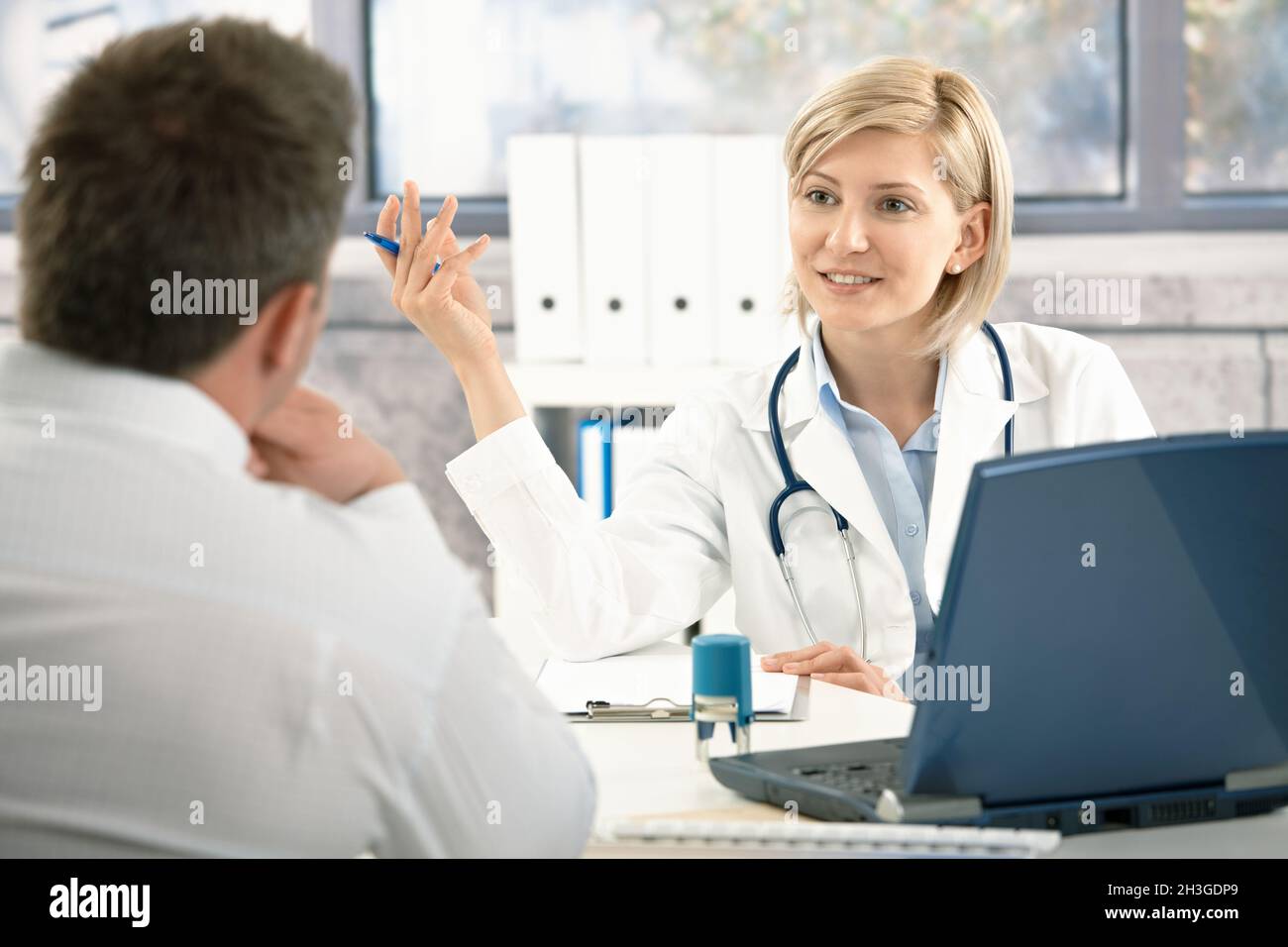 Clinician doctor man explaining patient hi-res stock photography and ...