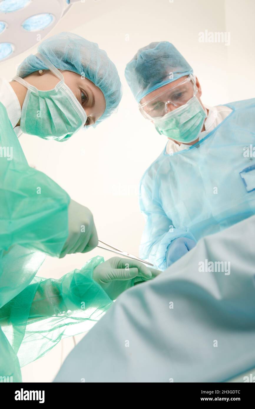 Surgeons working together Stock Photo - Alamy
