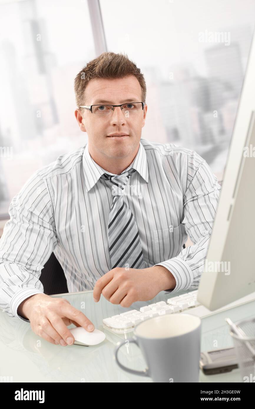 Portrait of businessman using desktop computer Stock Photo - Alamy