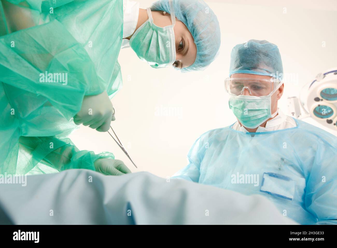Doctors operating patient Stock Photo - Alamy