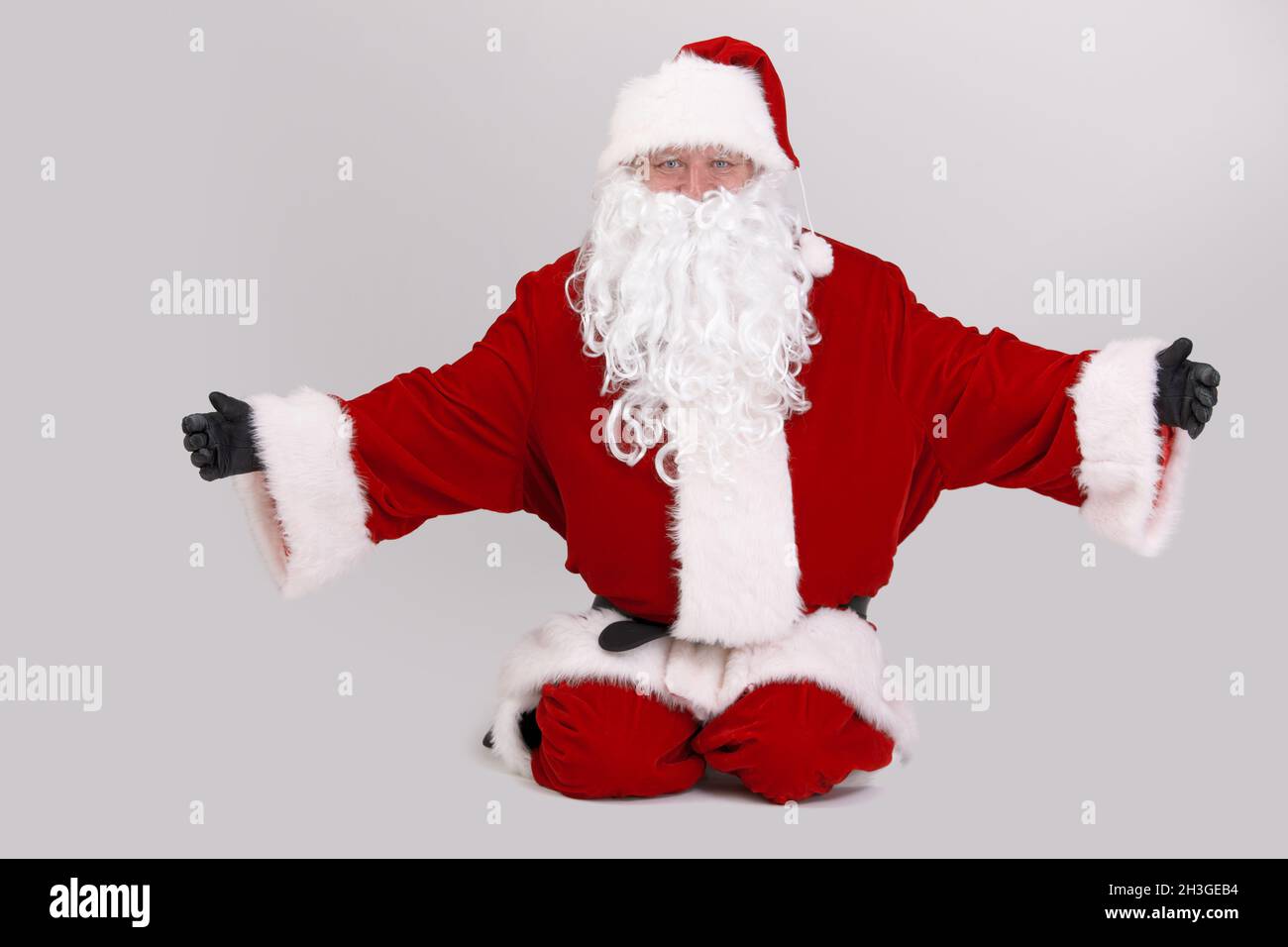 Santa kneeling outspreading arms Stock Photo - Alamy