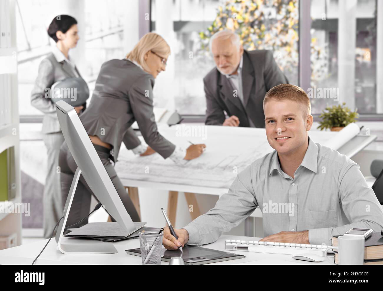 Four workers busy hi-res stock photography and images - Alamy