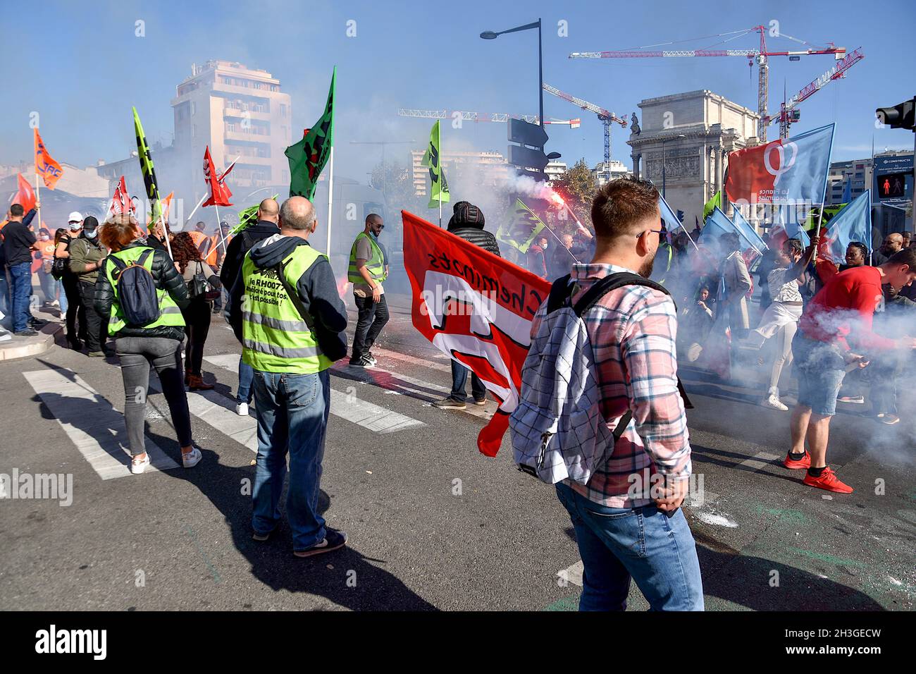 Protesters wave union flags and burn flares during the demonstration ...