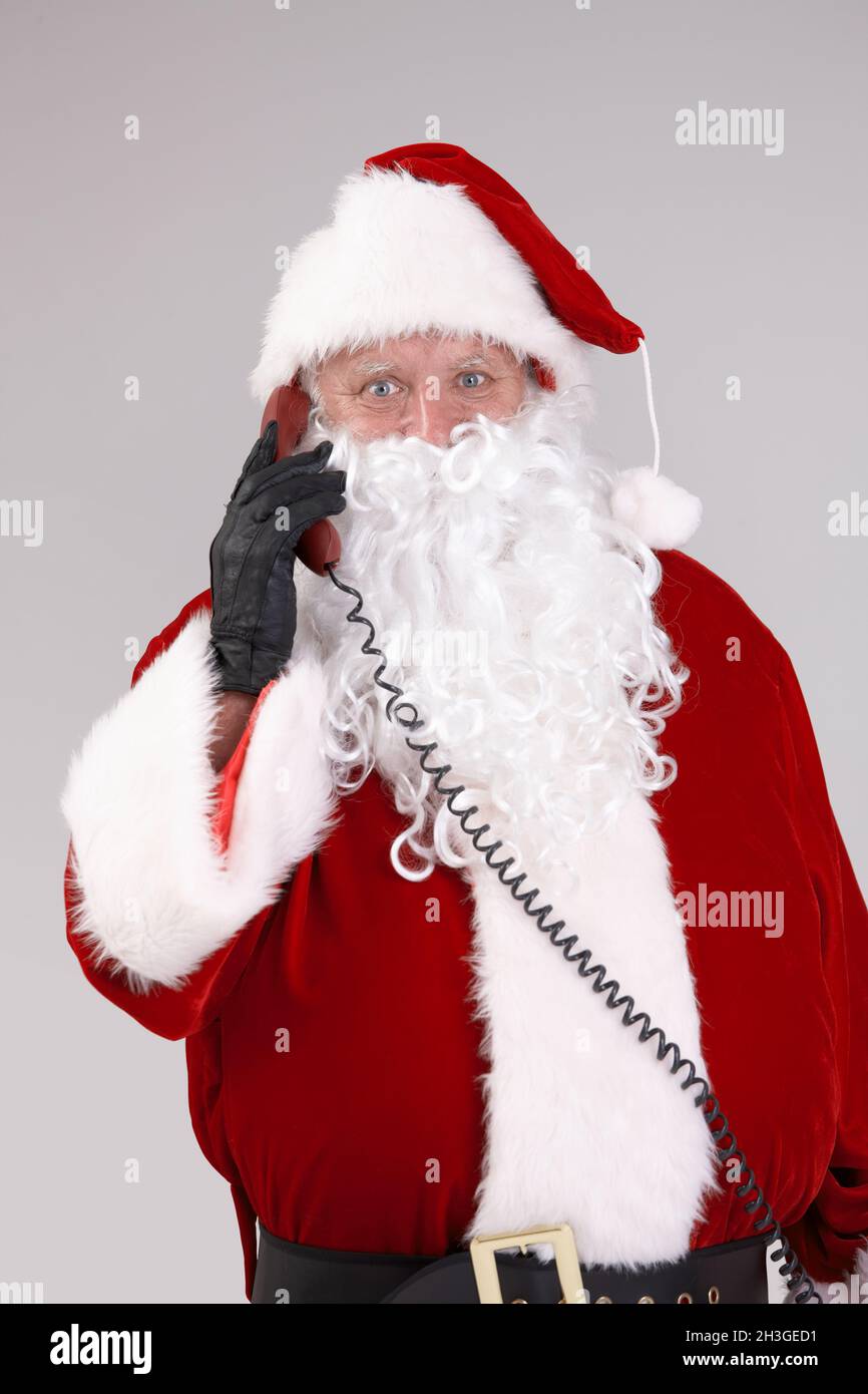Santa talking on phone looking at camera Stock Photo - Alamy
