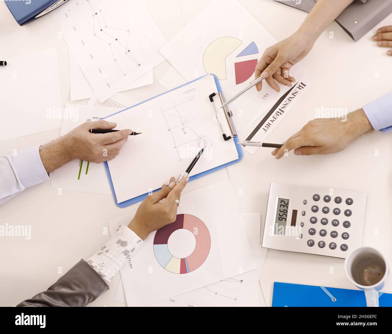 Four hands businessmen pointing paper hi-res stock photography and ...