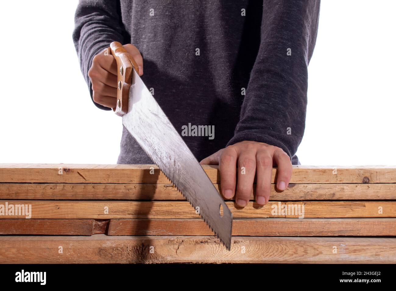 Man cutting wood with hand saw, isolated on white background. Carpenter ...