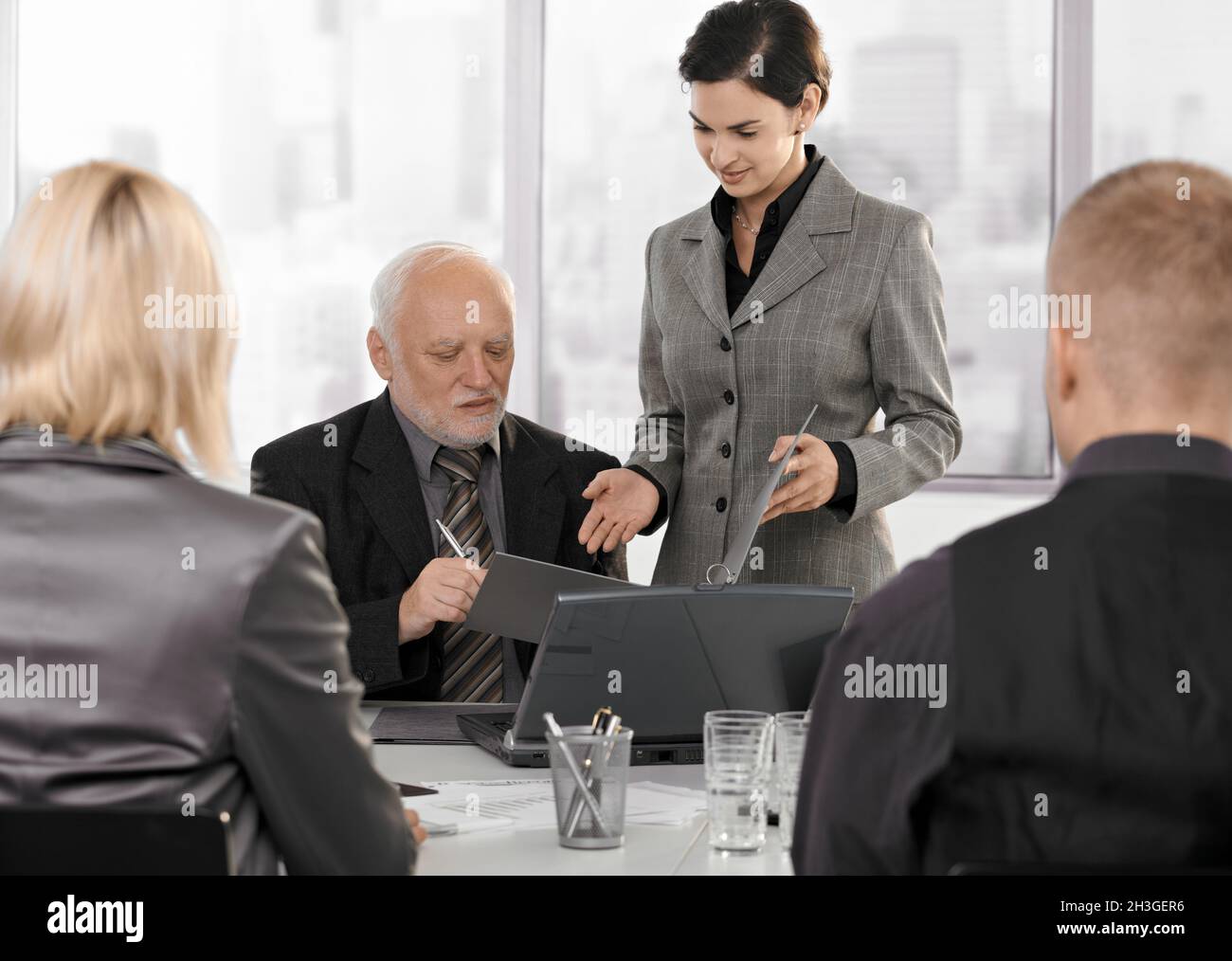 Secretary getting contract to sign by executive Stock Photo - Alamy