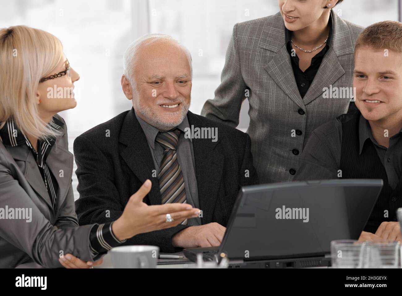 Businesswoman explaining work to colleagues Stock Photo - Alamy