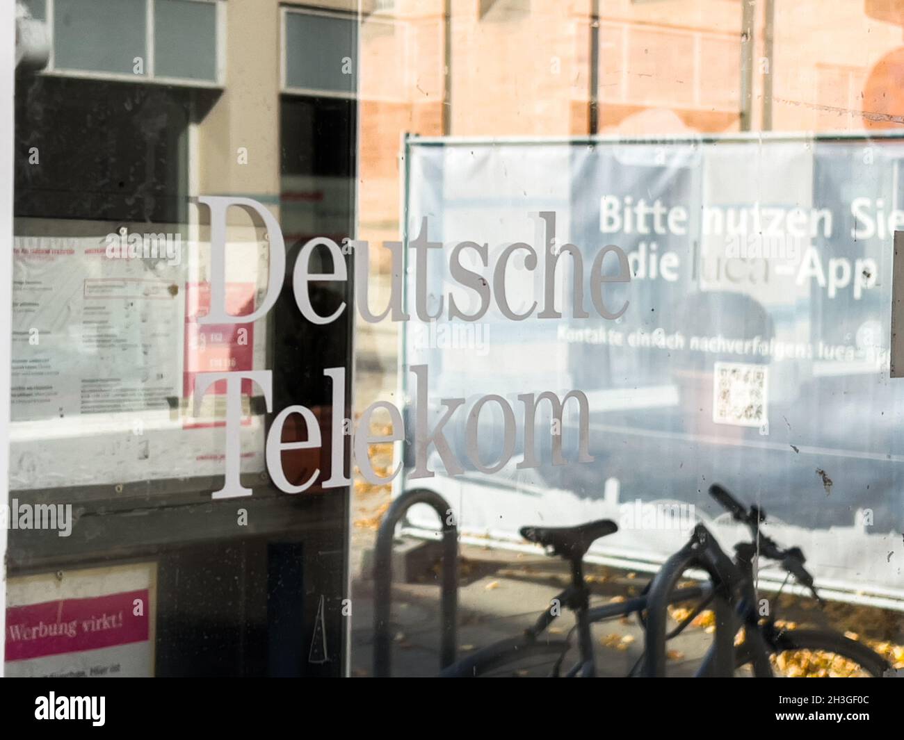 Deutsche Telecom signage on the door of old phone booth in city center ...