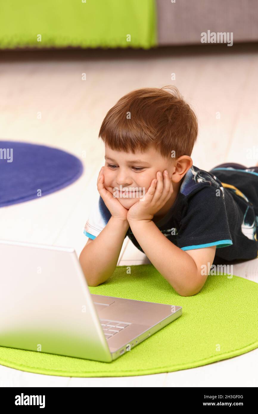 Little boy using computer at home Stock Photo - Alamy