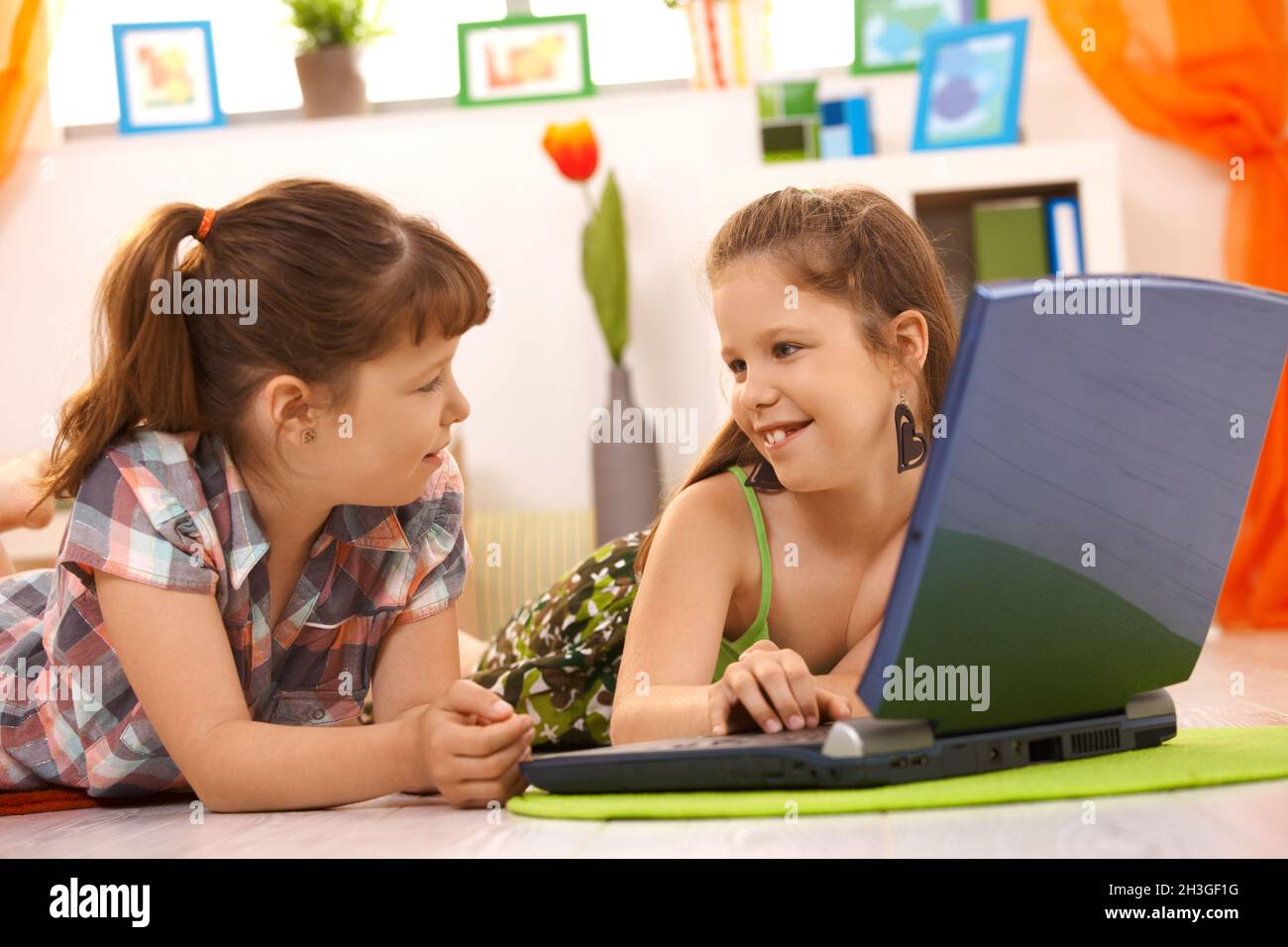 Little girls using computer at home Stock Photo - Alamy