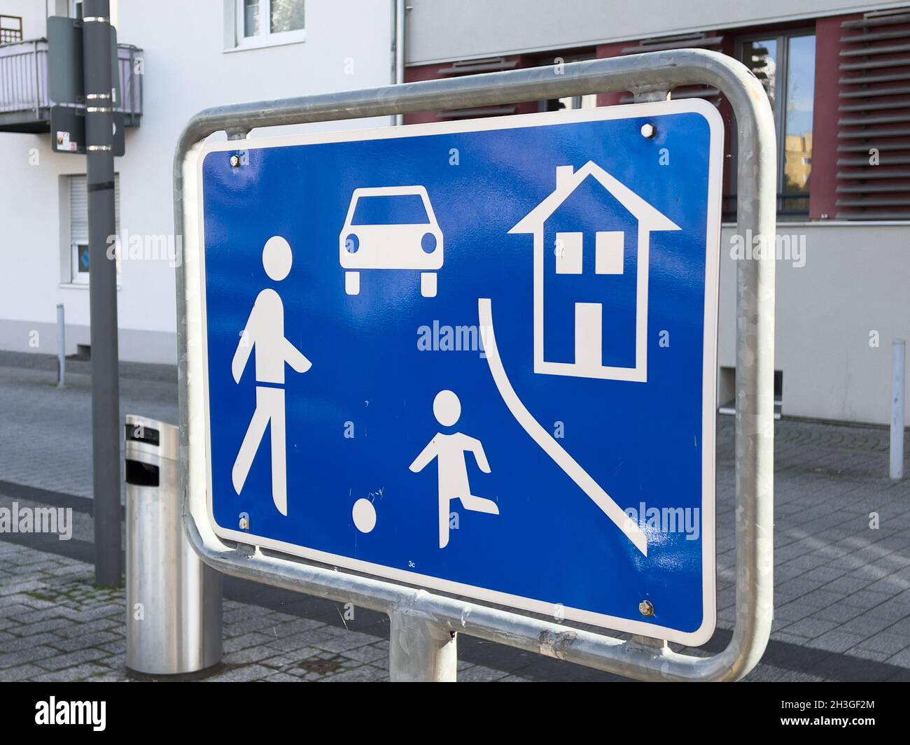 German street with blue sign warning for driver entering pedestrian ...