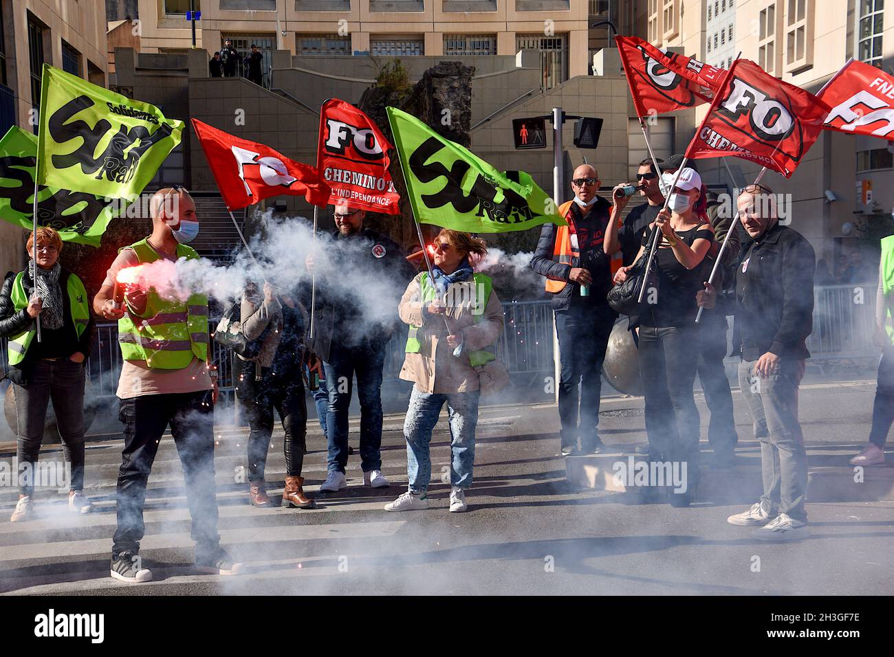 Protesters wave union flags and burn flares during the demonstration ...