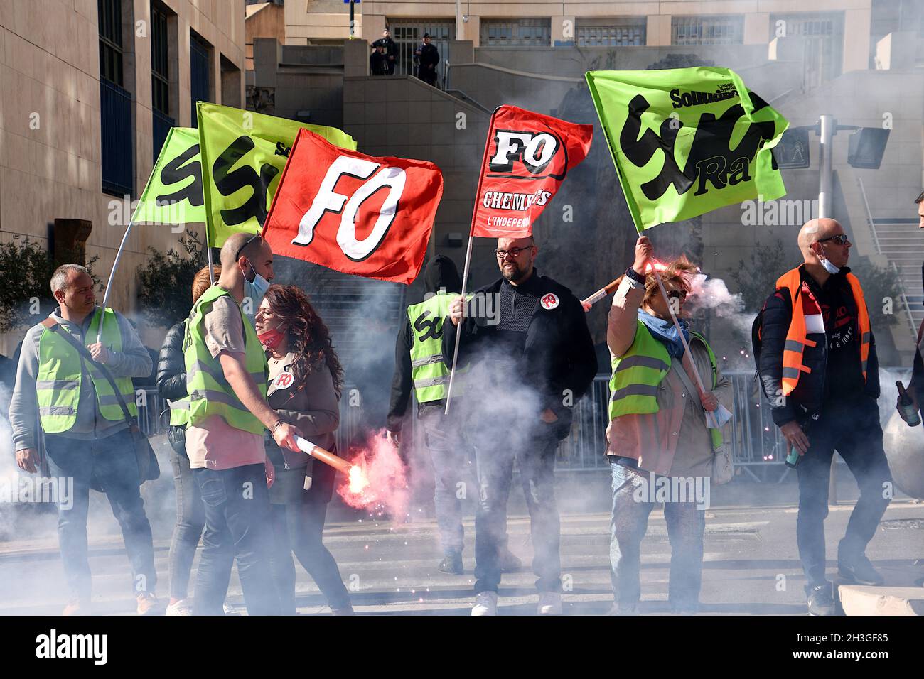 Protesters wave union flags and burn flares during the demonstration ...