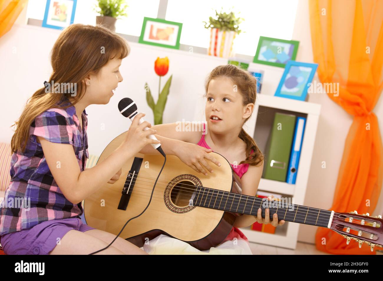 Girls playing music and singing Stock Photo - Alamy