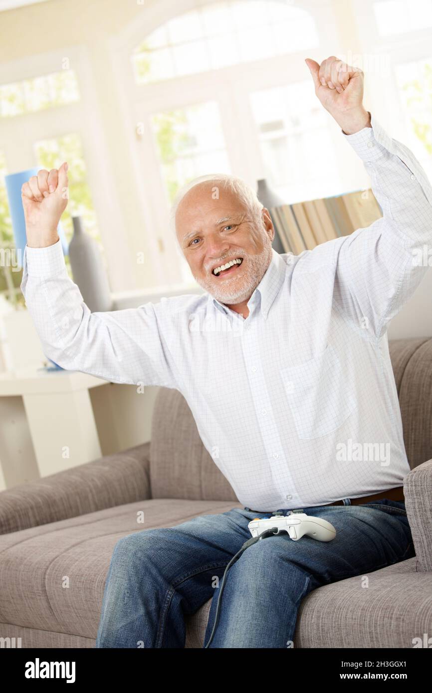 Senior happy winning computer game Stock Photo - Alamy