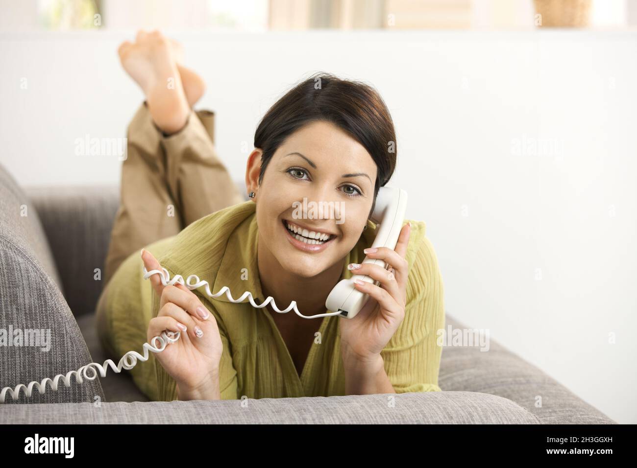 Attractive smiling woman lying prone hi-res stock photography and ...