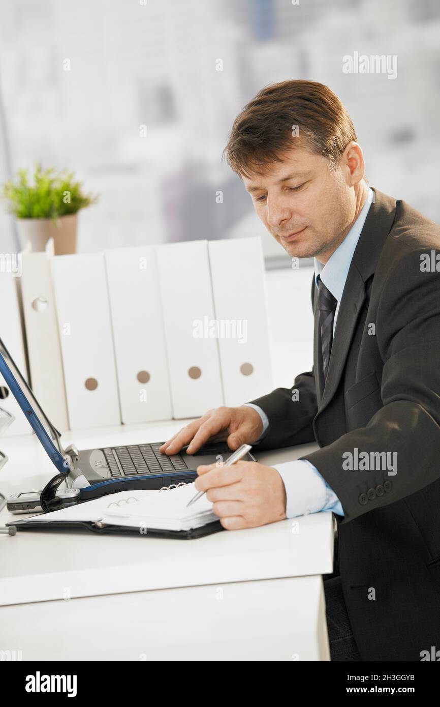 Businessman writing notes using hi-res stock photography and images - Alamy