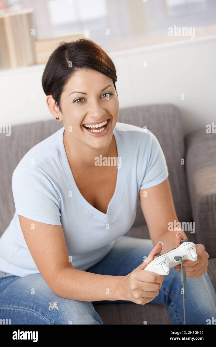 Excited woman playing video game Stock Photo - Alamy
