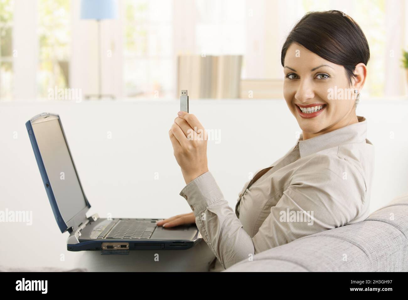Woman showing flash drive Stock Photo - Alamy