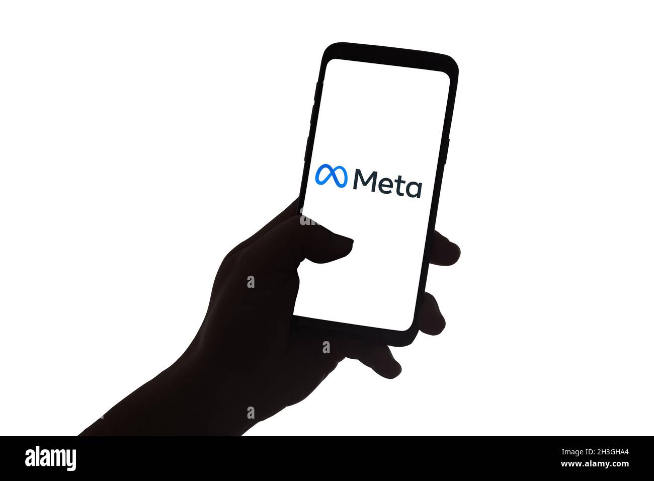 hand holding a mobile phone showing meta logo Stock Photo - Alamy