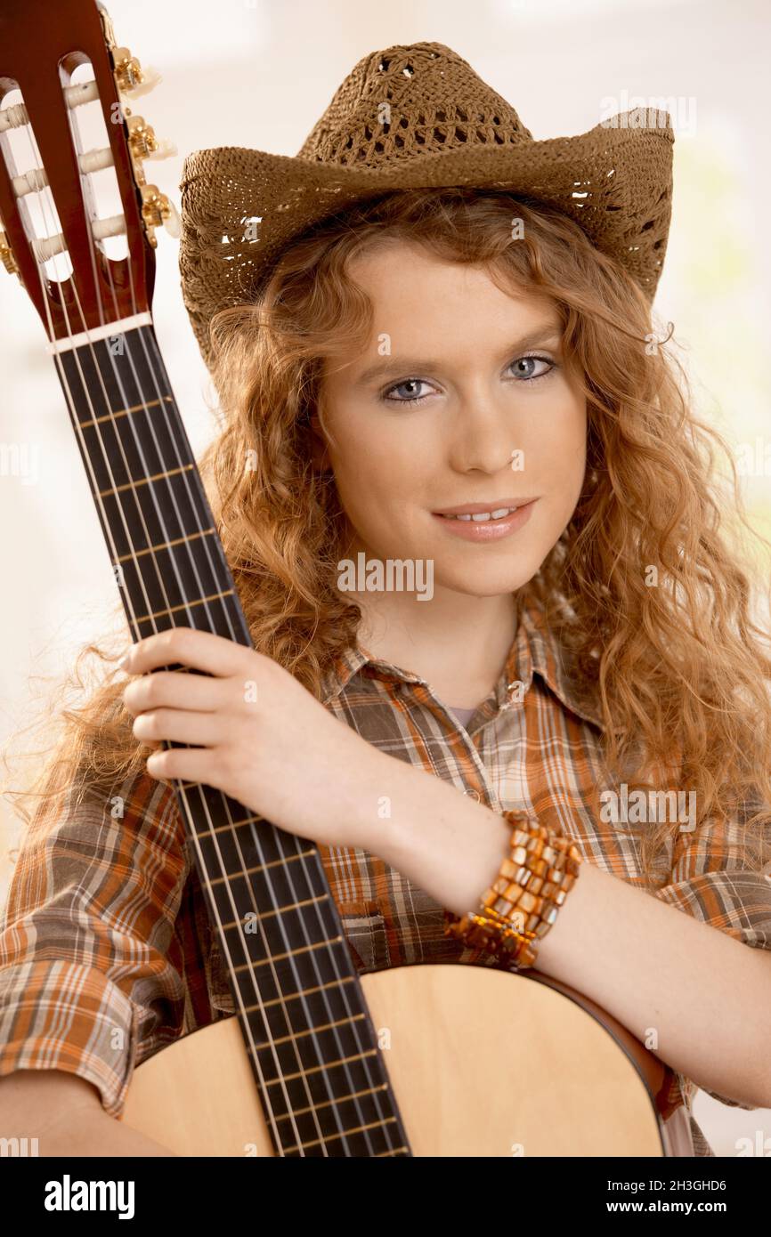 Attractive female hugging guitar Stock Photo - Alamy