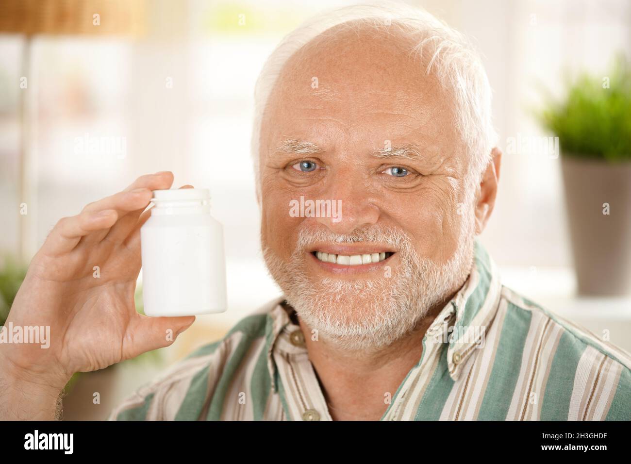 Happy senior man holding medication Stock Photo - Alamy
